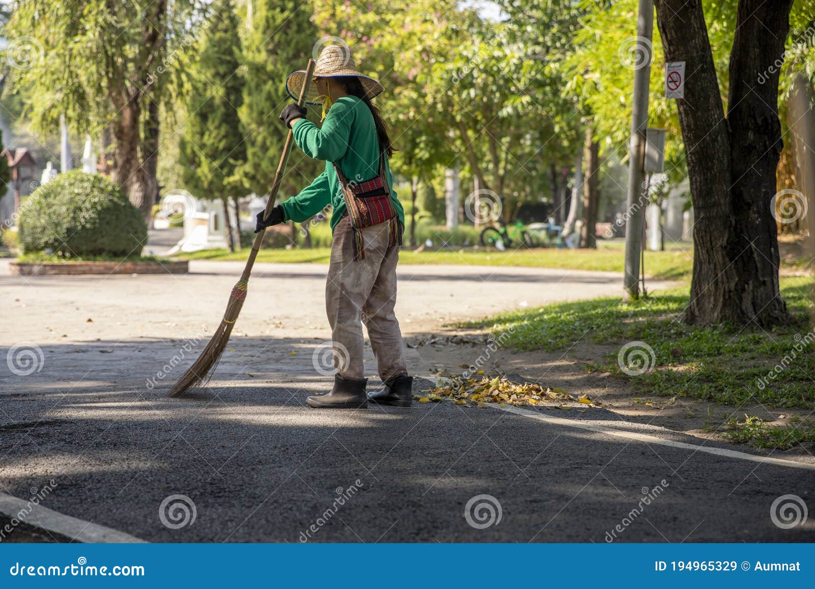 Workers are Sweeping the Pavement with Broom that Fall on the Street in ...