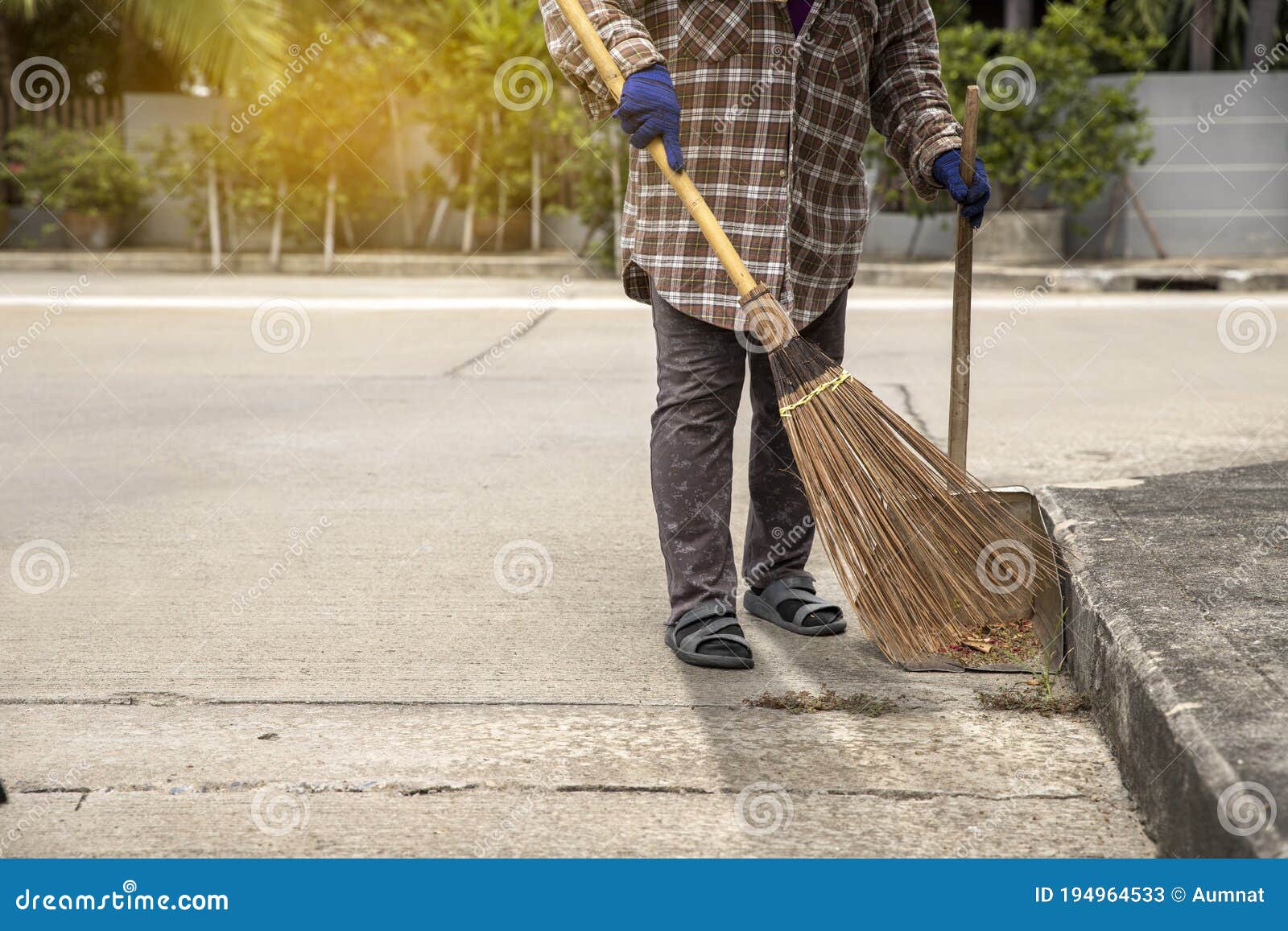 Workers are Sweeping the Pavement with Broom that Fall on the Street ...