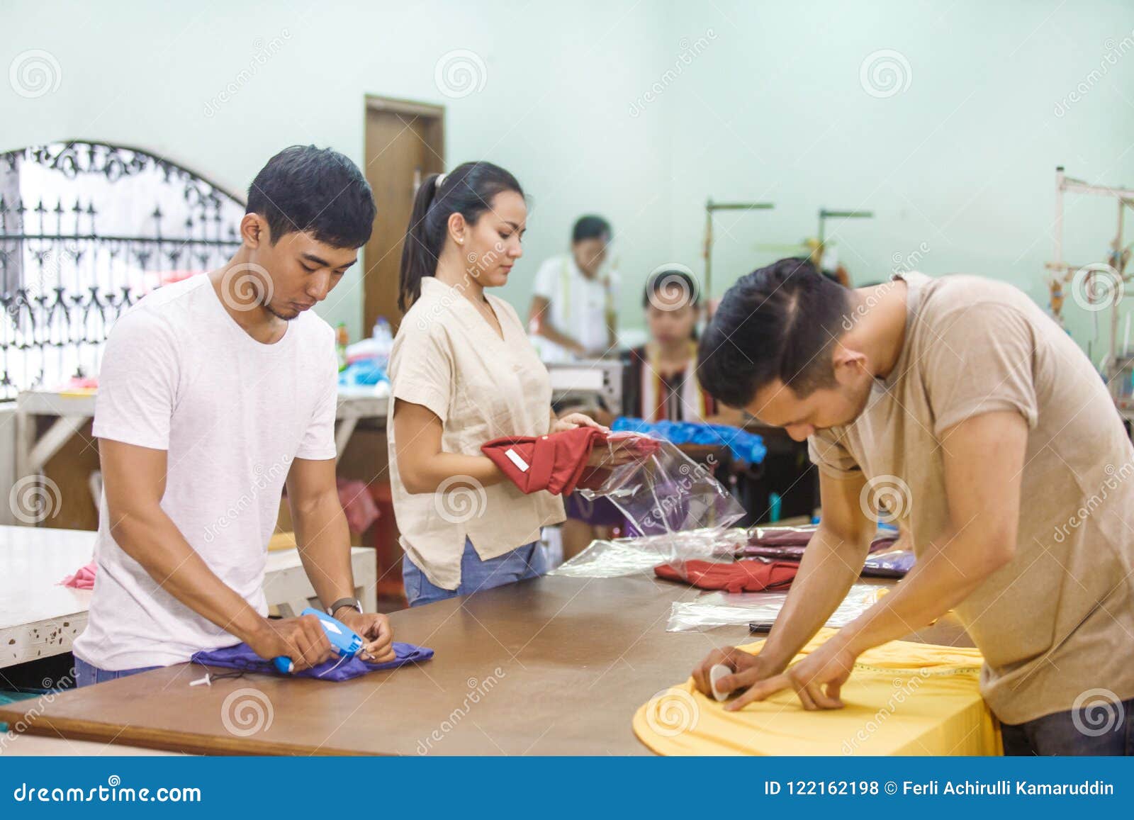 Workers at Textile Company Marking a Fabric, Labelling, and Pack Stock ...