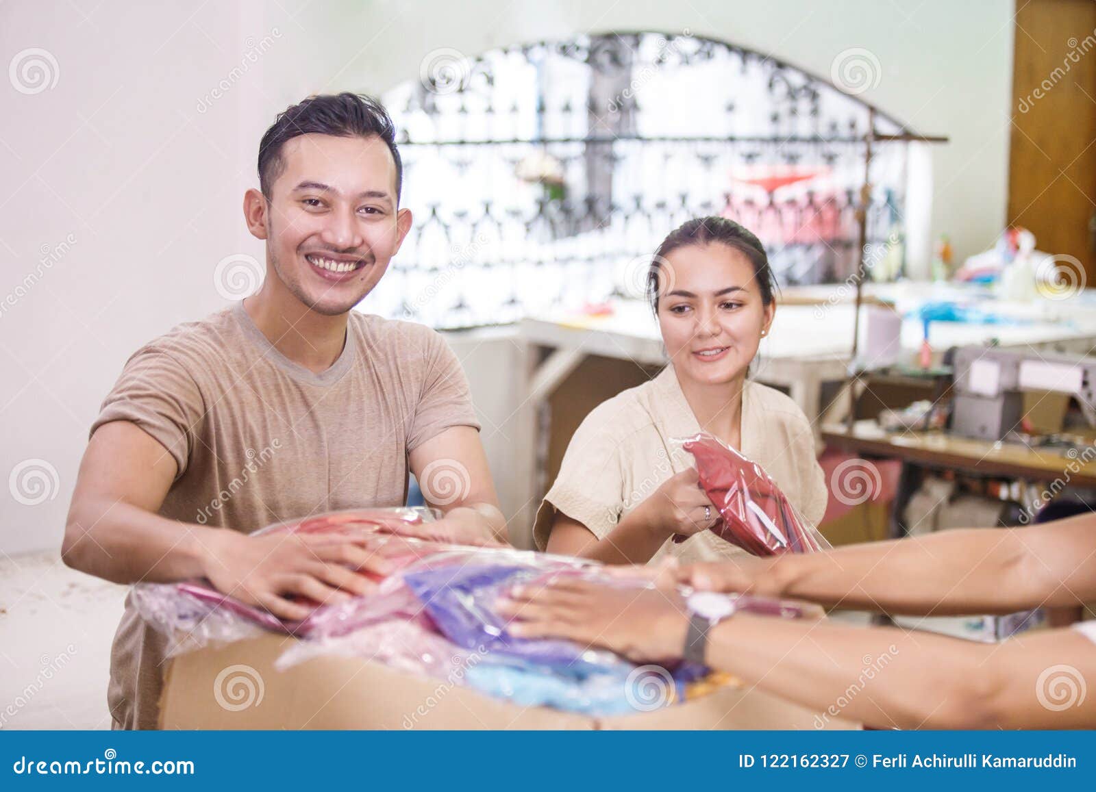 Workers at Textile Company Stacking Their Products into a Box Stock ...
