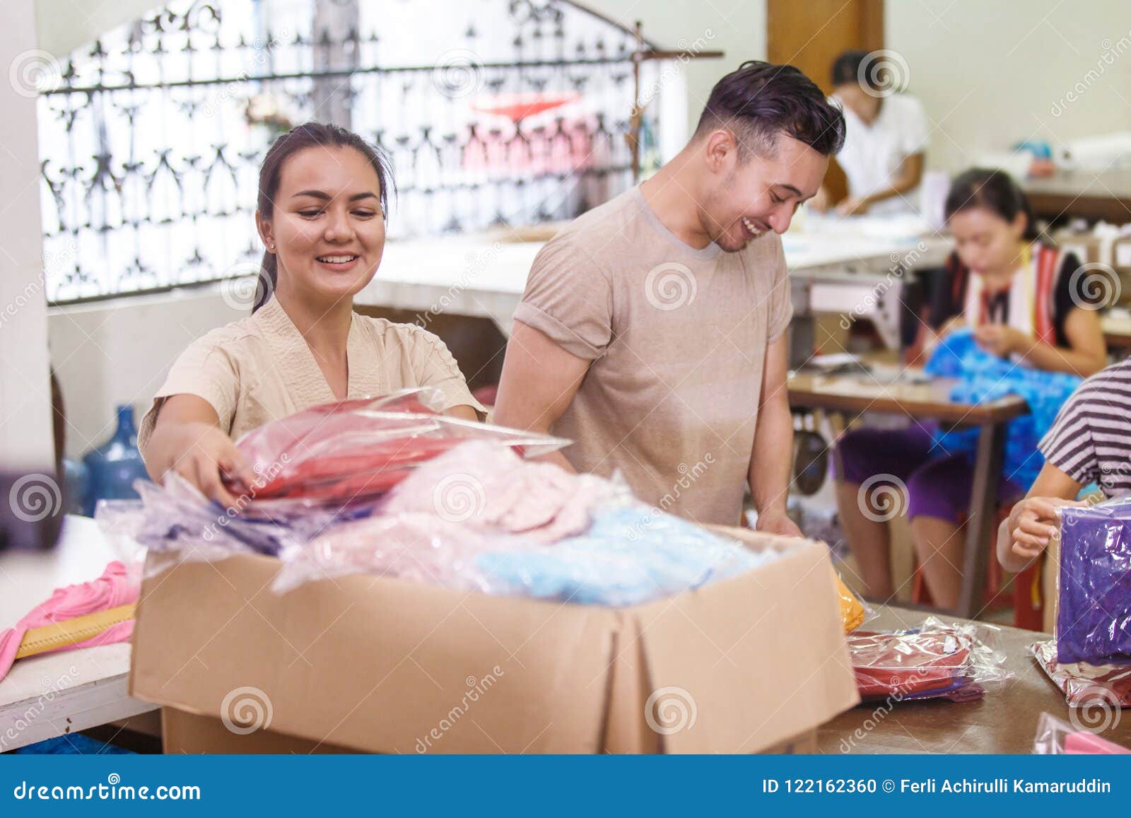 Workers at Textile Company Stacking Their Products into a Box Stock ...