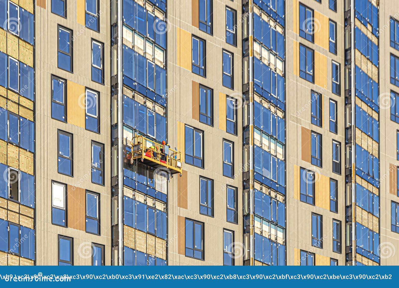 Workers in Uniform, in a Construction Cradle, on the Facade of a Tall ...