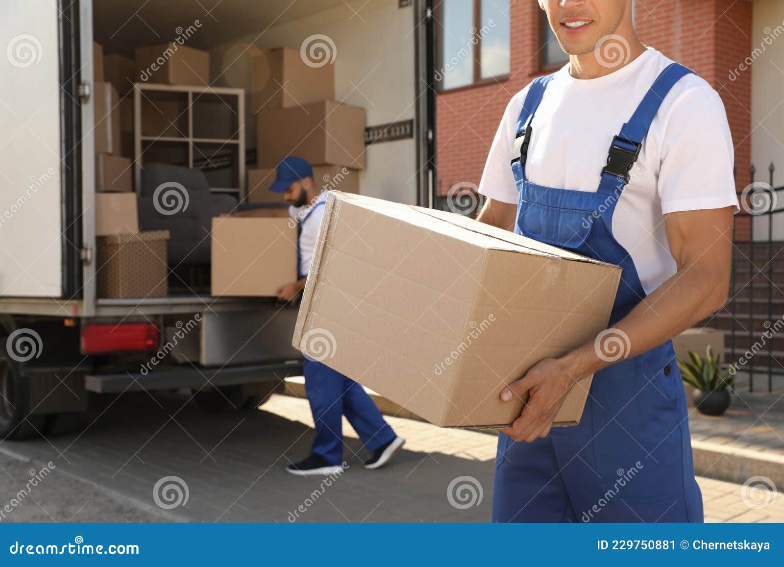 Workers Unloading Boxes from Van Outdoors. Moving Service Stock Image ...
