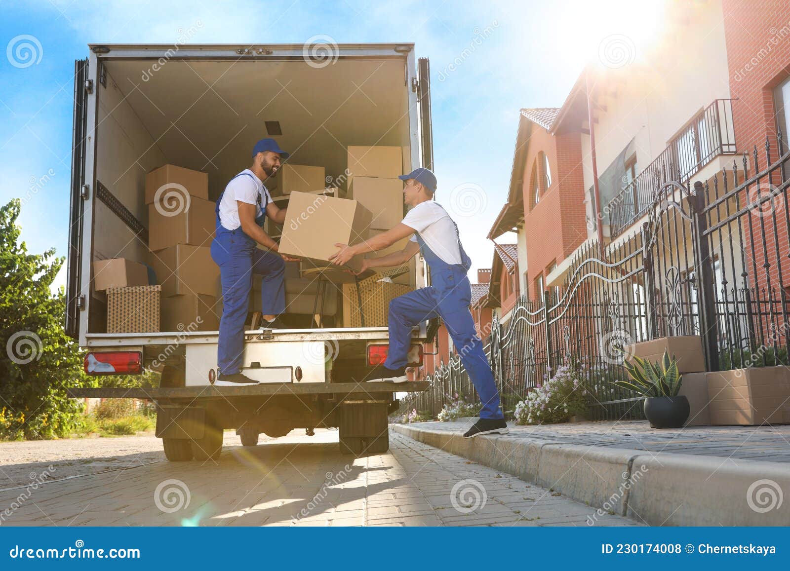 Workers Unloading Boxes from Van Outdoors. Moving Service Stock Photo ...