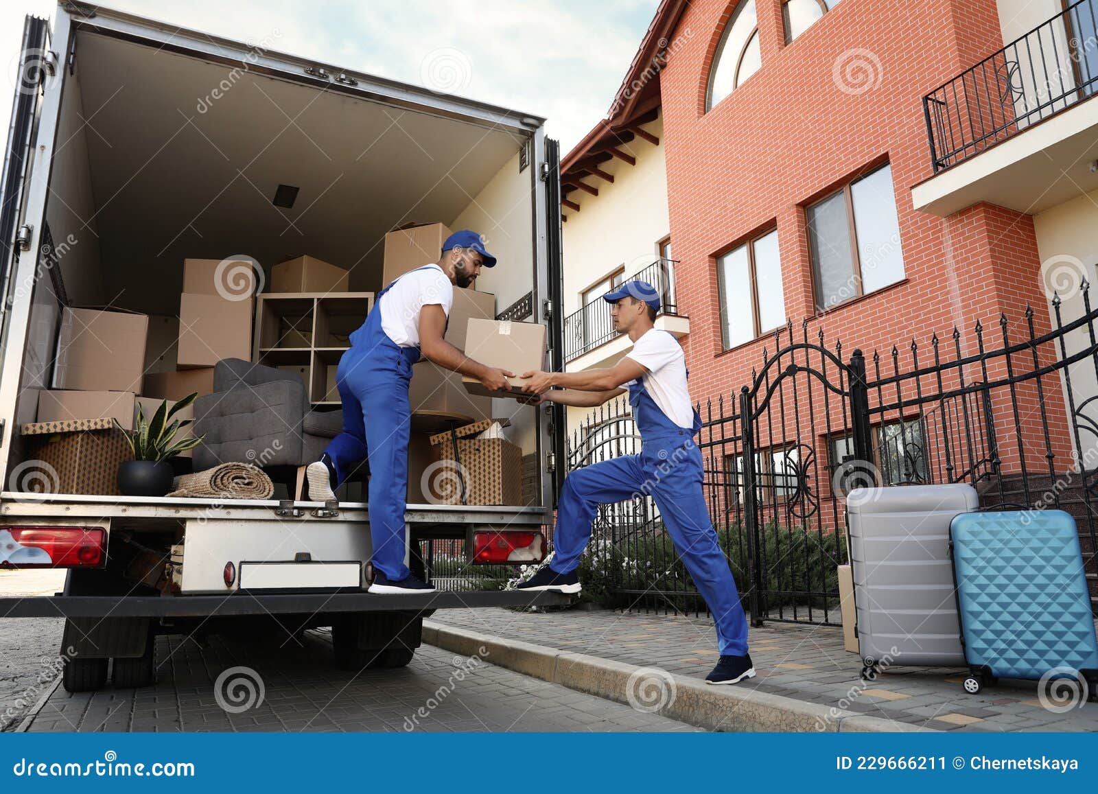 Workers Unloading Boxes from Van Outdoors. Moving Service Stock Image ...