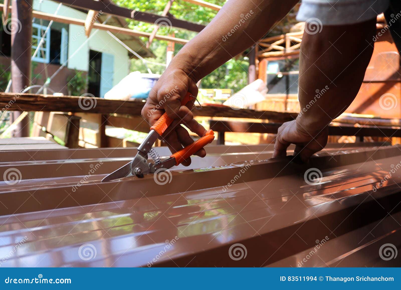 Workers Use Scissors To Cut the Metal Sheet for Roofing. Stock Photo ...