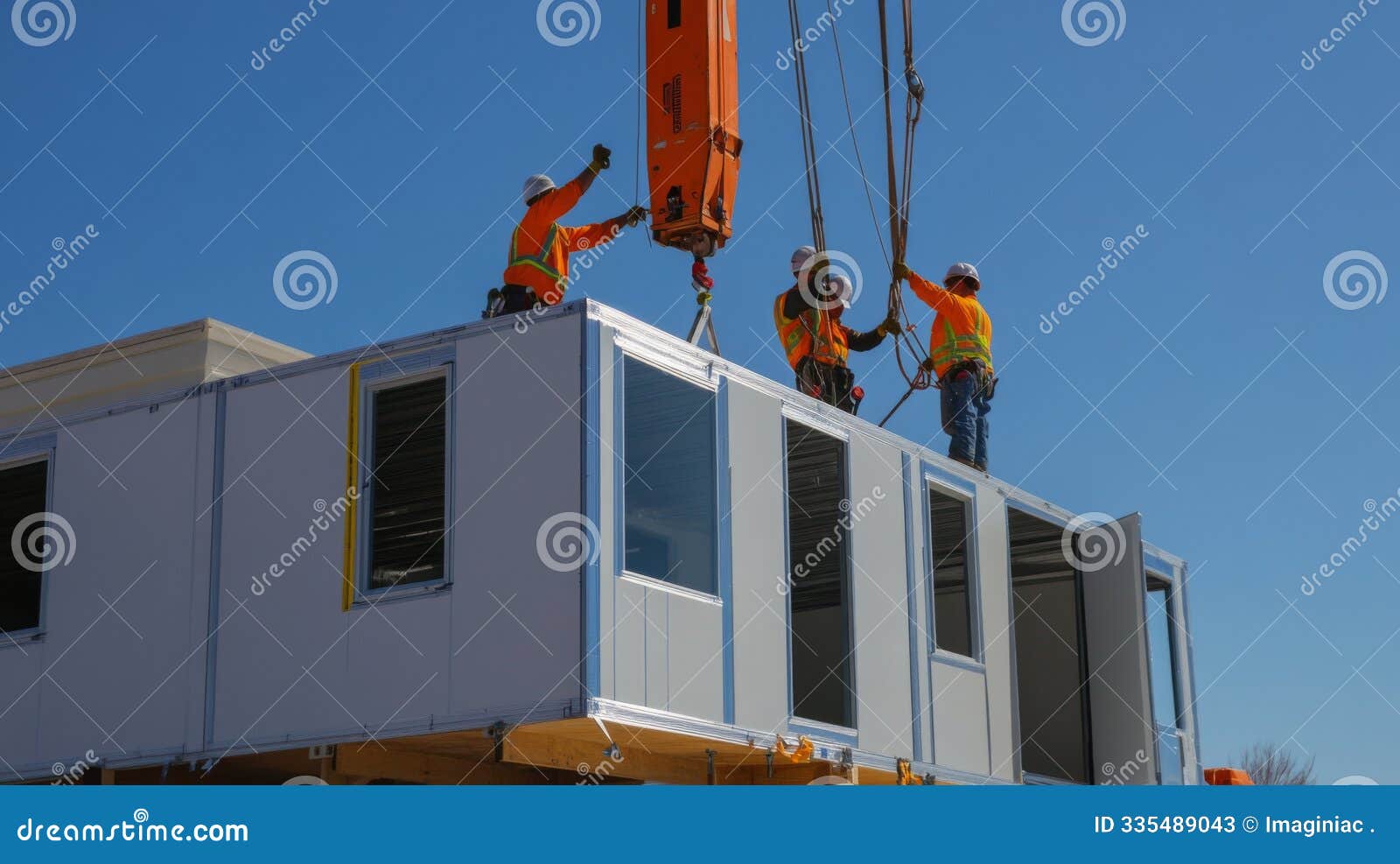Workers Using a Crane To Lift a Modular Building Section Stock ...