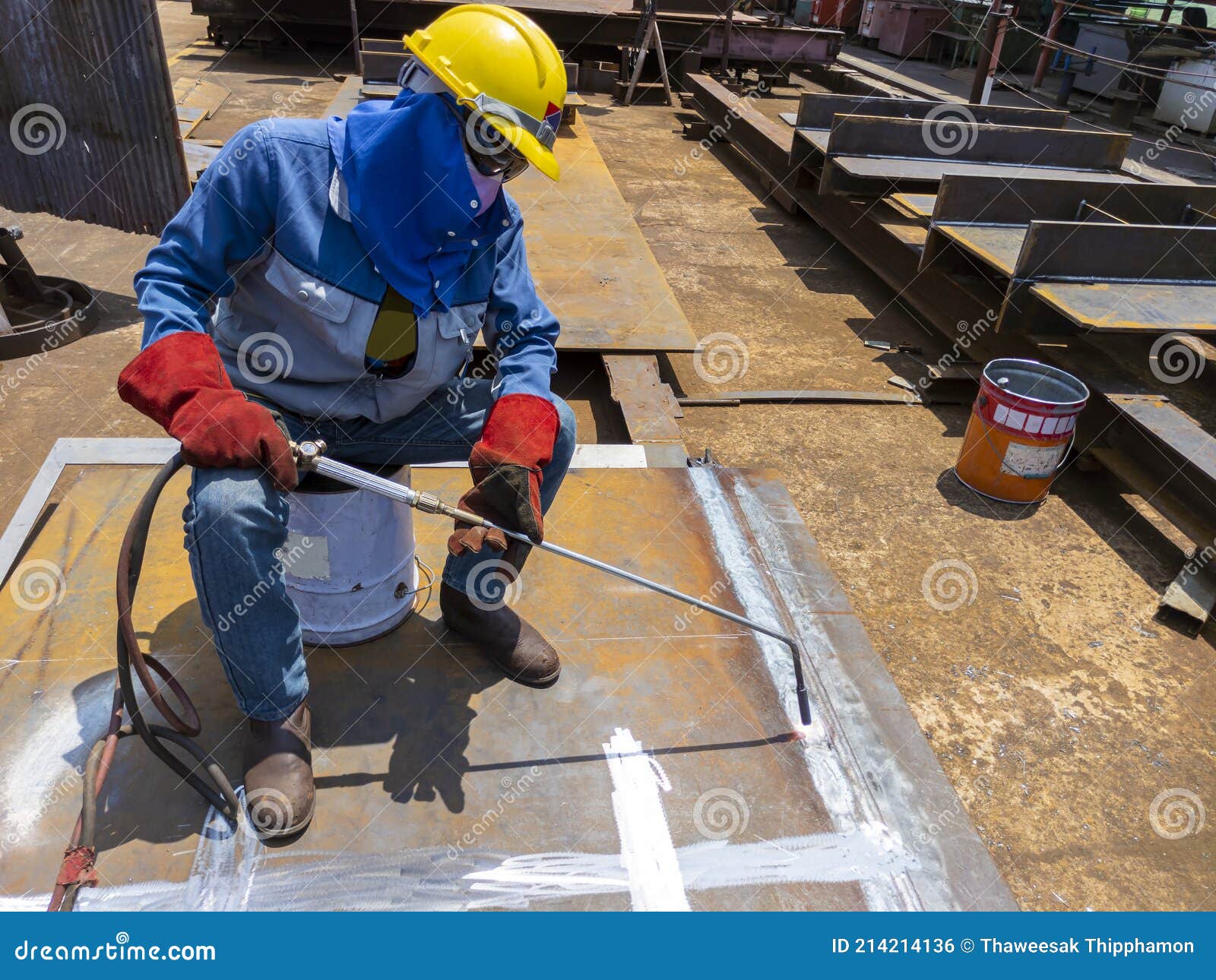 Workers are Using Heating Torch To Burning Bending Steel Plates that is ...