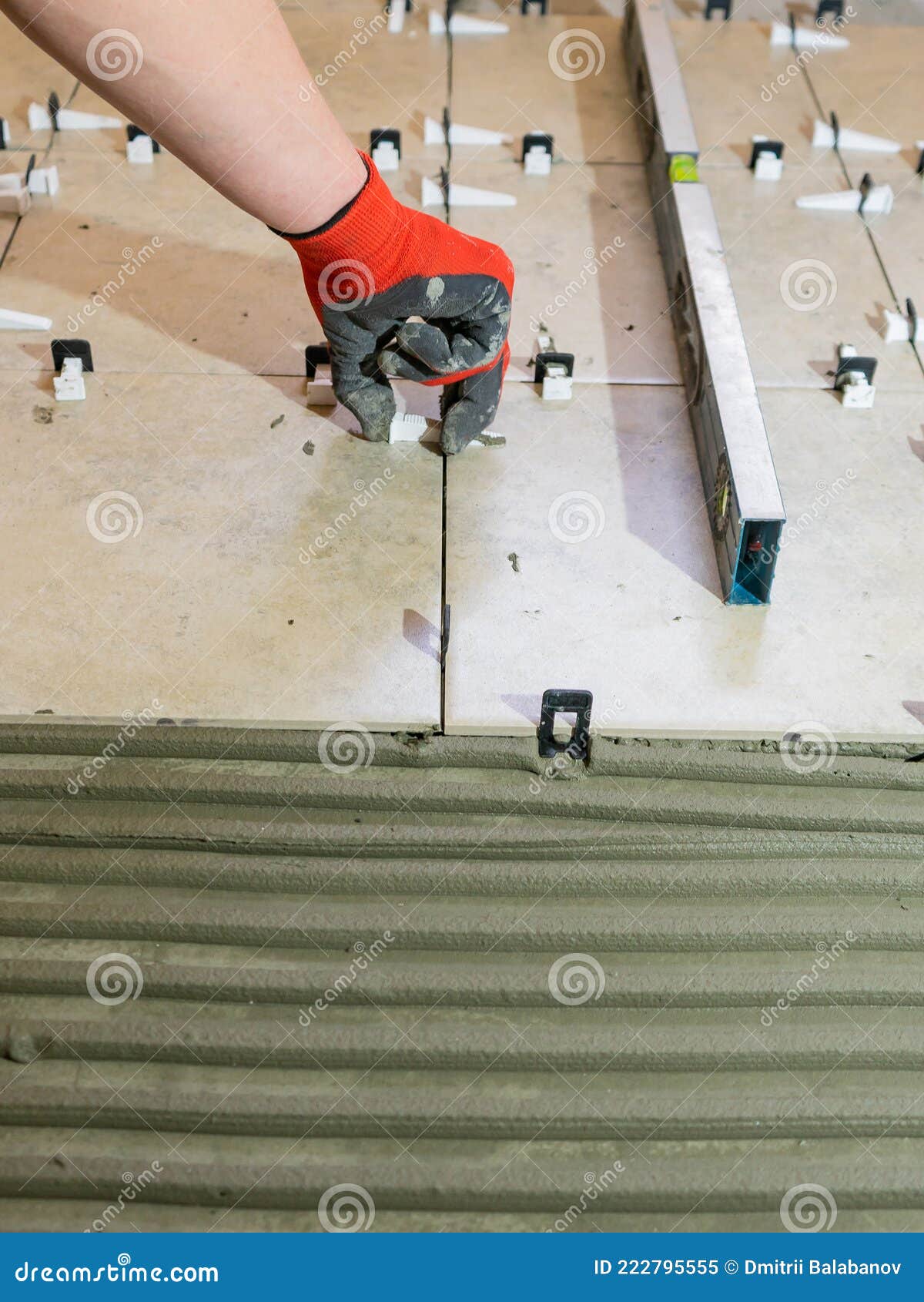 Workers are Using Plastic Clamps and Wedges To Leveling the Ceramic ...