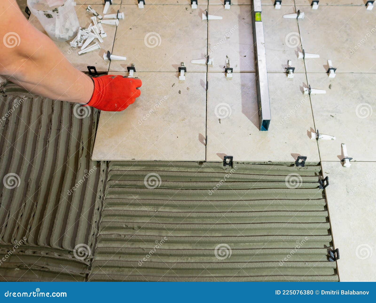 Workers are Using Plastic Clamps and Wedges To Leveling the Ceramic ...