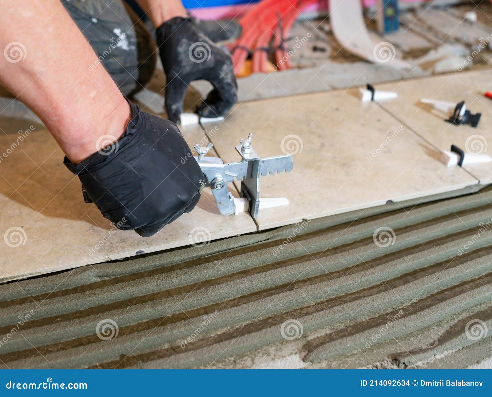 Workers are Using Plastic Clamps and Wedges To Leveling the Ceramic ...