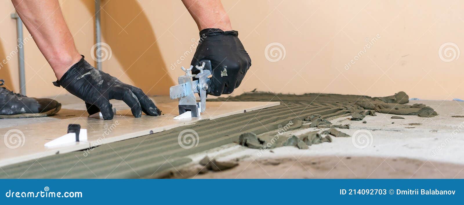 Workers are Using Plastic Clamps and Wedges To Leveling the Ceramic ...