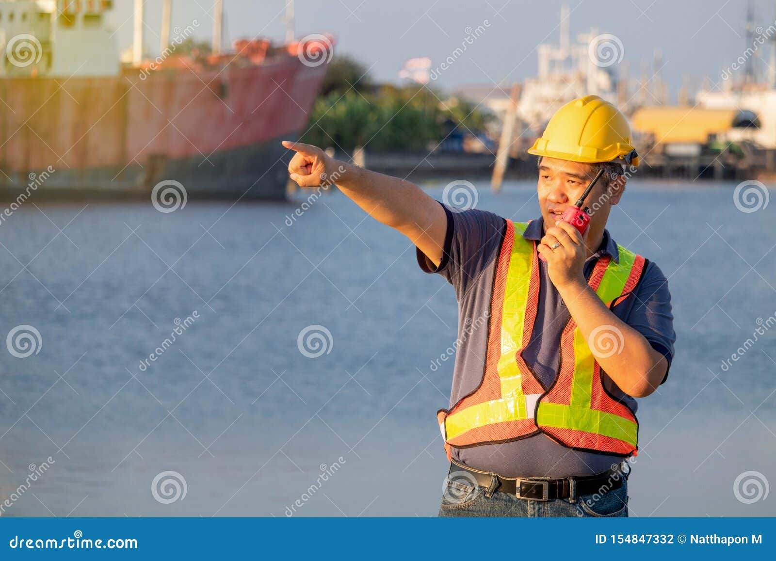 Workers are Using Radio Communication and Pointing Forward at Shipping ...