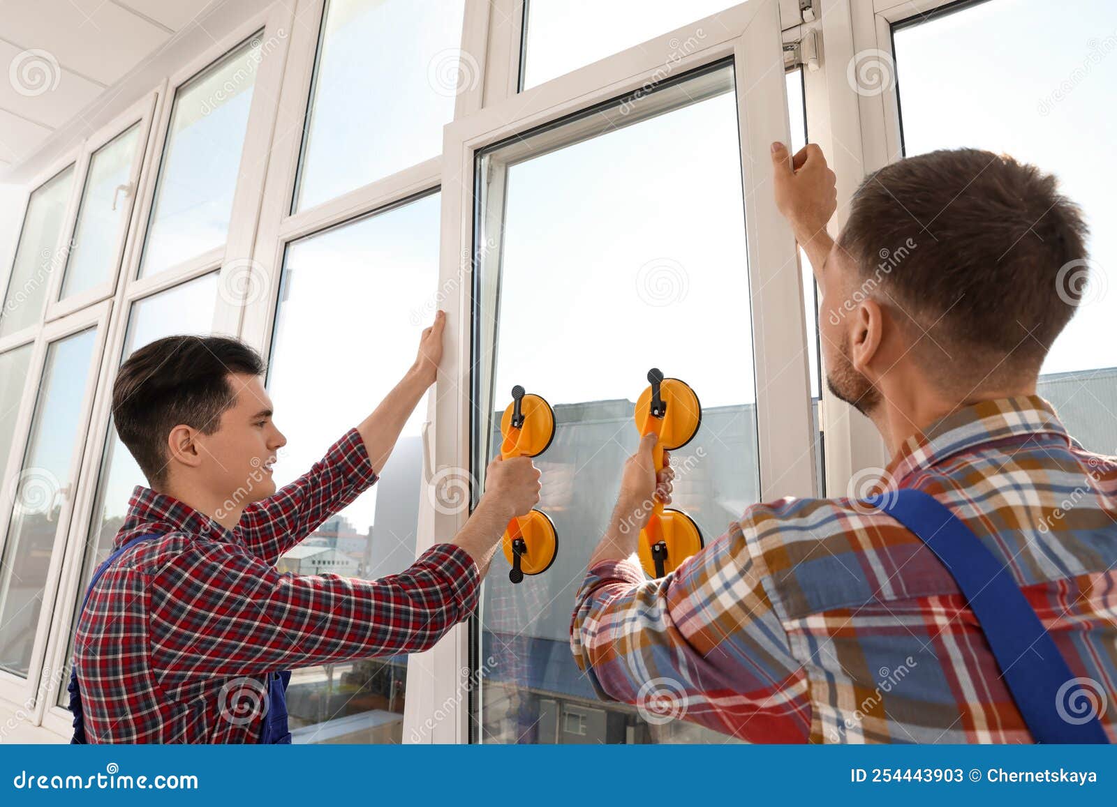 Workers Using Suction Lifters during Plastic Window Installation Stock ...
