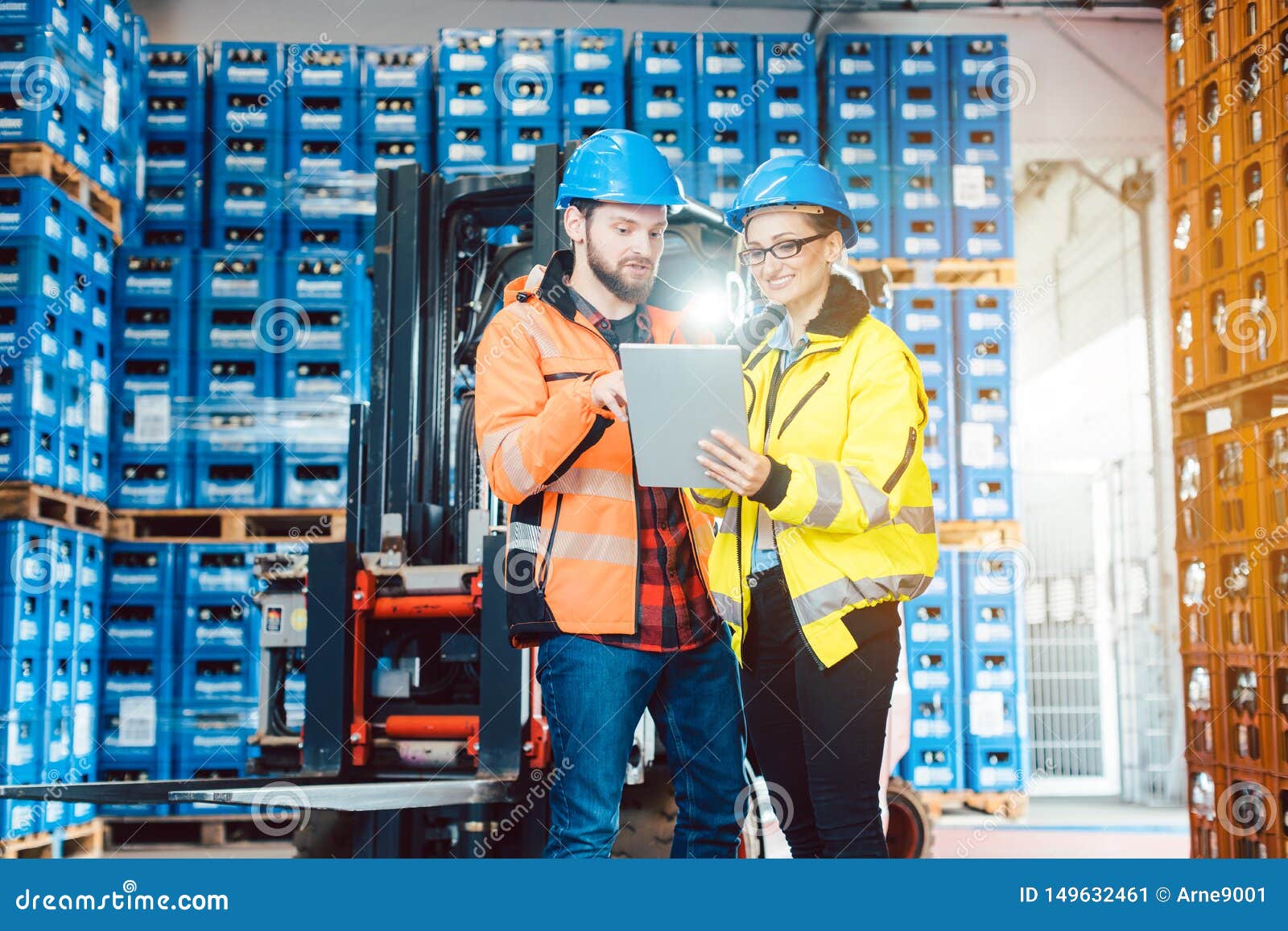 Workers in Warehouse Checking Data on Tablet Computer Stock Image ...