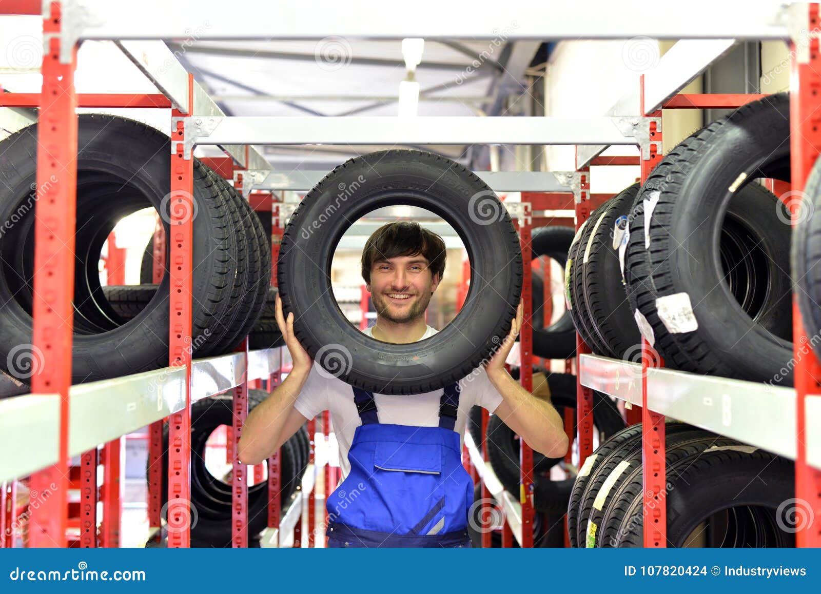 Workers in a Warehouse with Tyres for Changing the Car Stock Photo ...