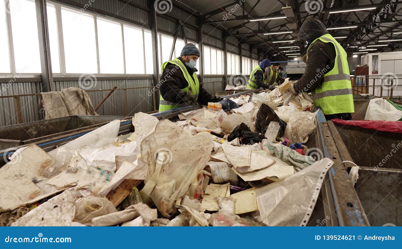 Workers at the Waste Processing Plant. Sorting Trash on a Conveyor Belt ...
