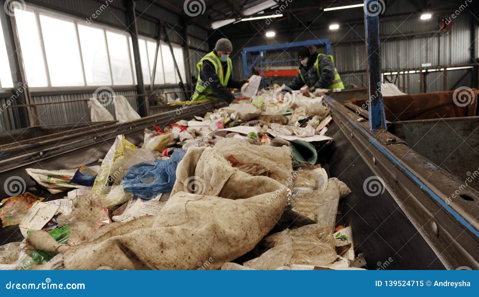 Workers at the Waste Processing Plant. Sorting Trash on a Conveyor Belt ...