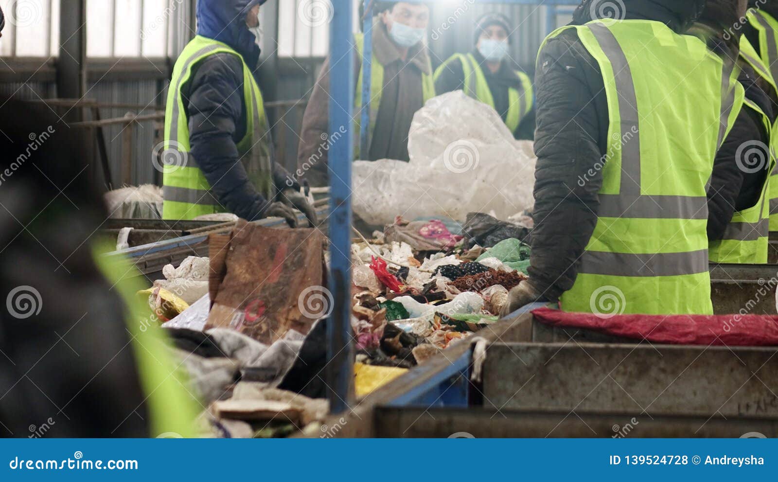 Workers At The Waste Processing Plant. Sorting Trash On A Conveyor Belt ...