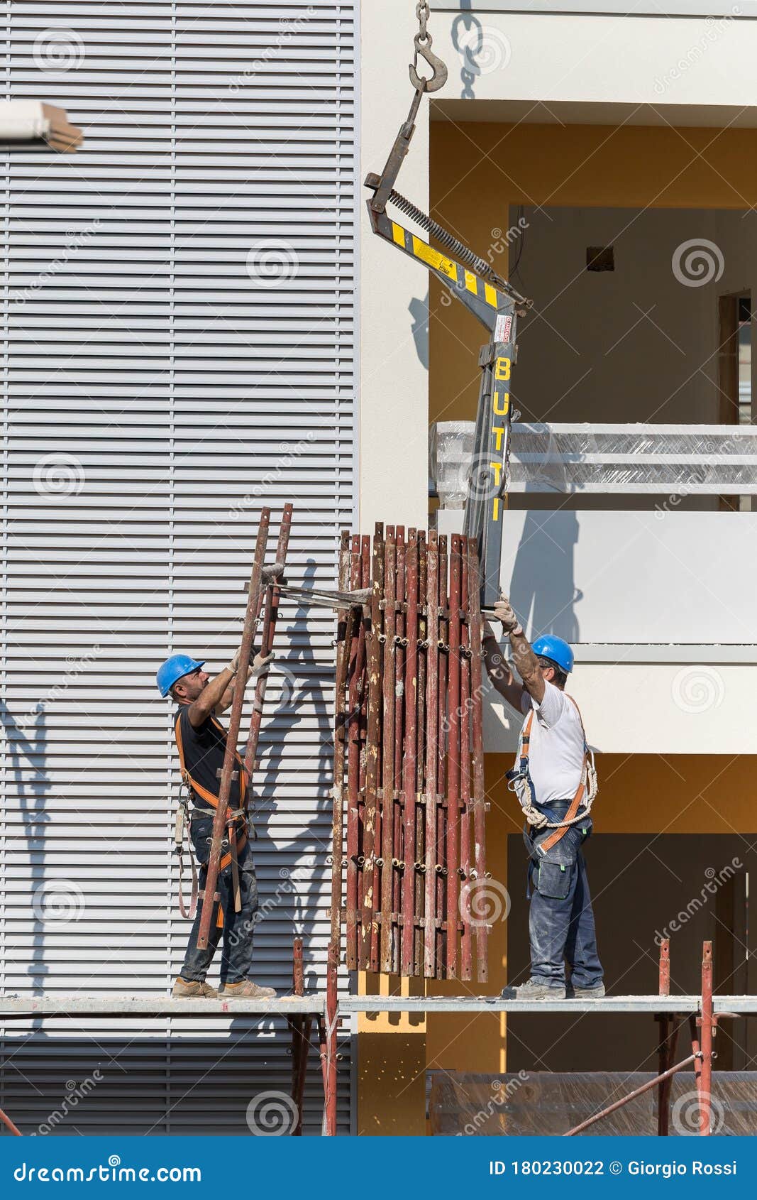 Workers at Work on a Scaffold in a Building Site for the Construction ...