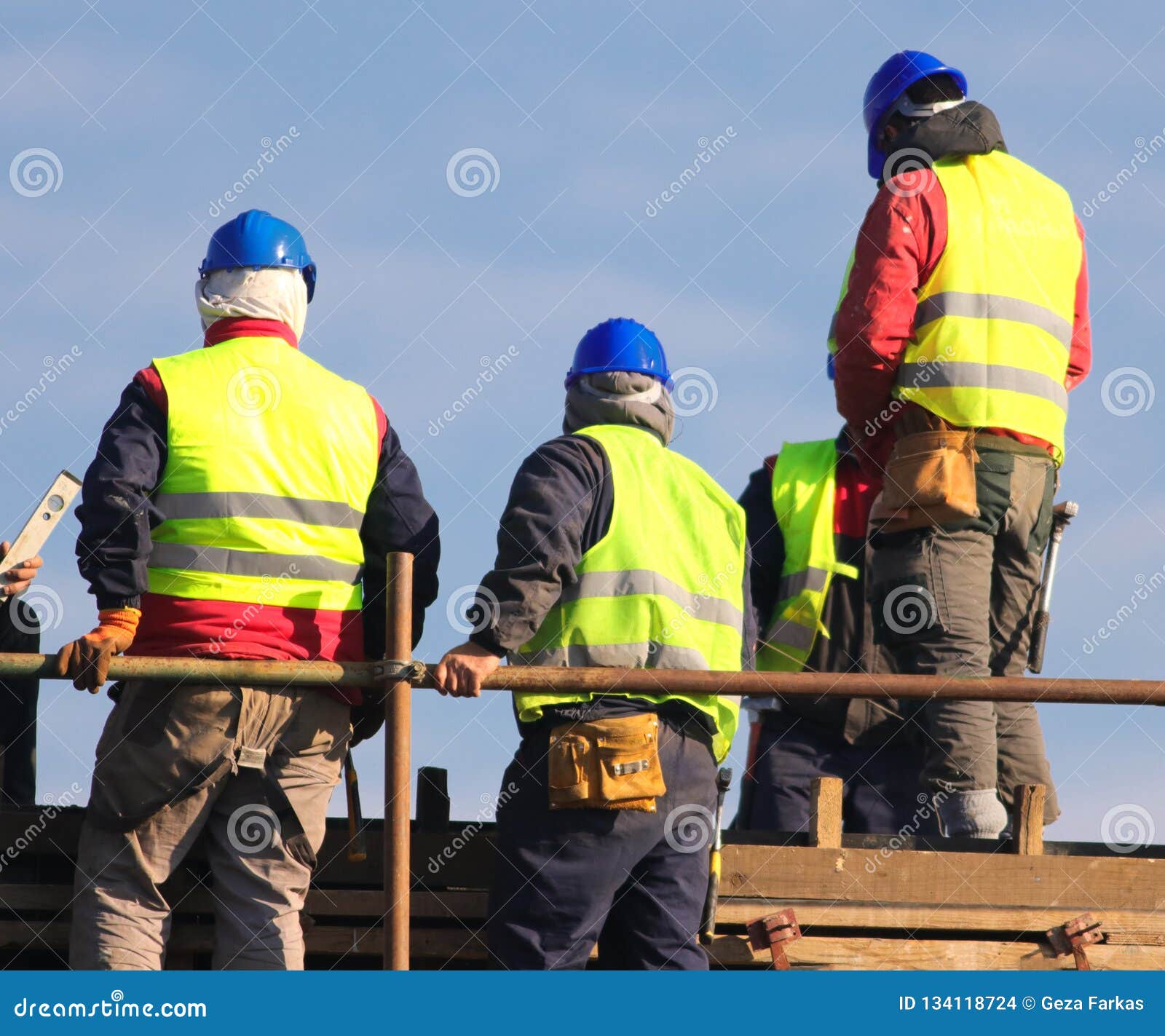 Workers in Yellow and Blue Helmet on the Construction Site Stock Photo ...