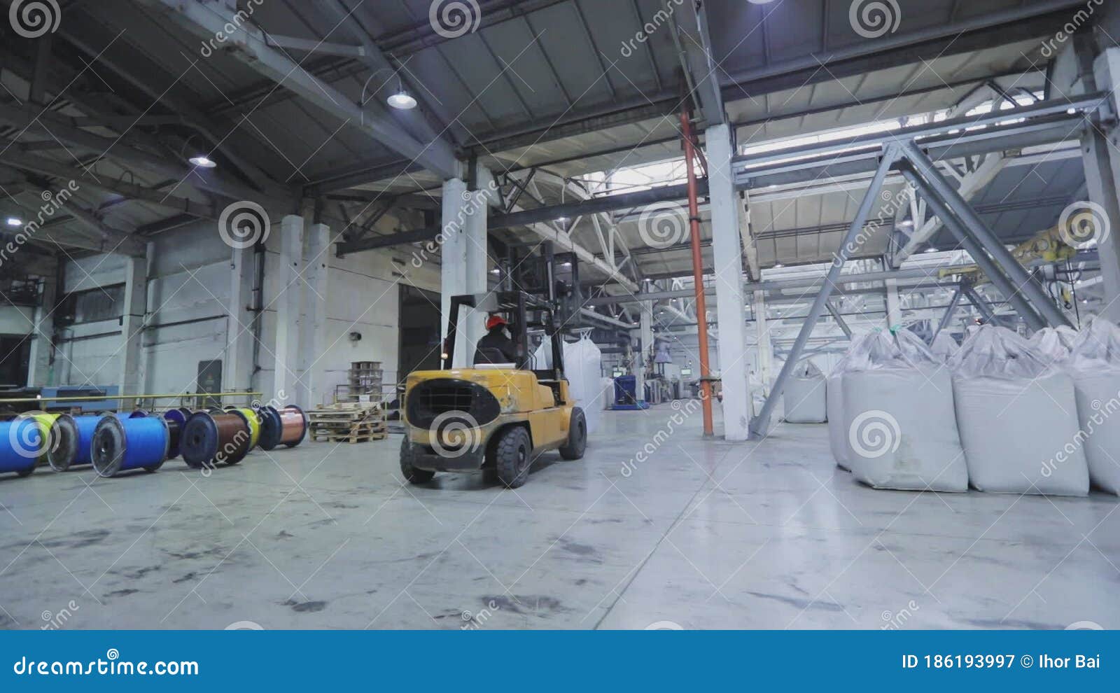 A Forklift Transports Cargo in a Factory Warehouse. Stock Video - Video ...
