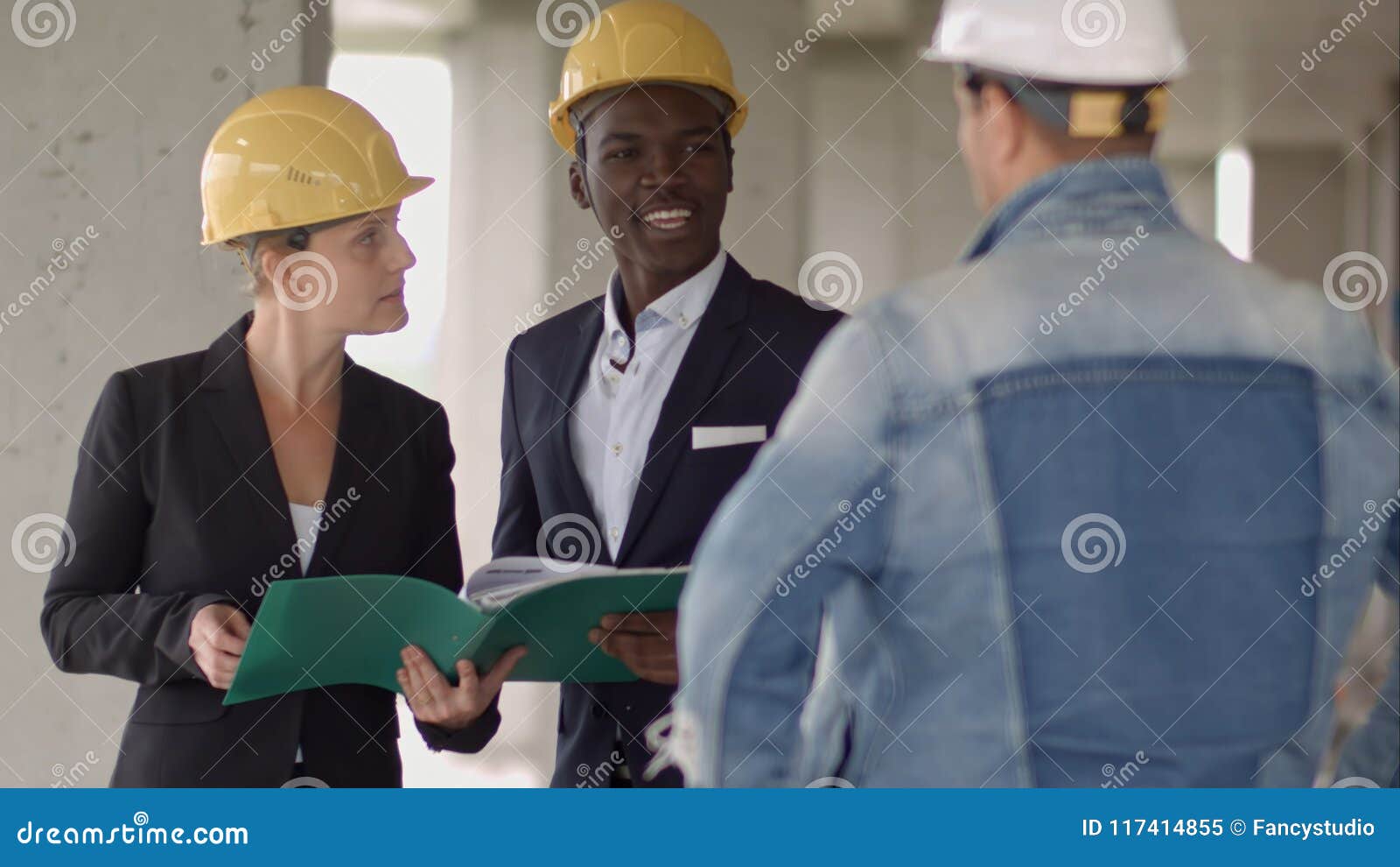 Workgroup of Builders Looking at New Project and Discussing it Stock ...