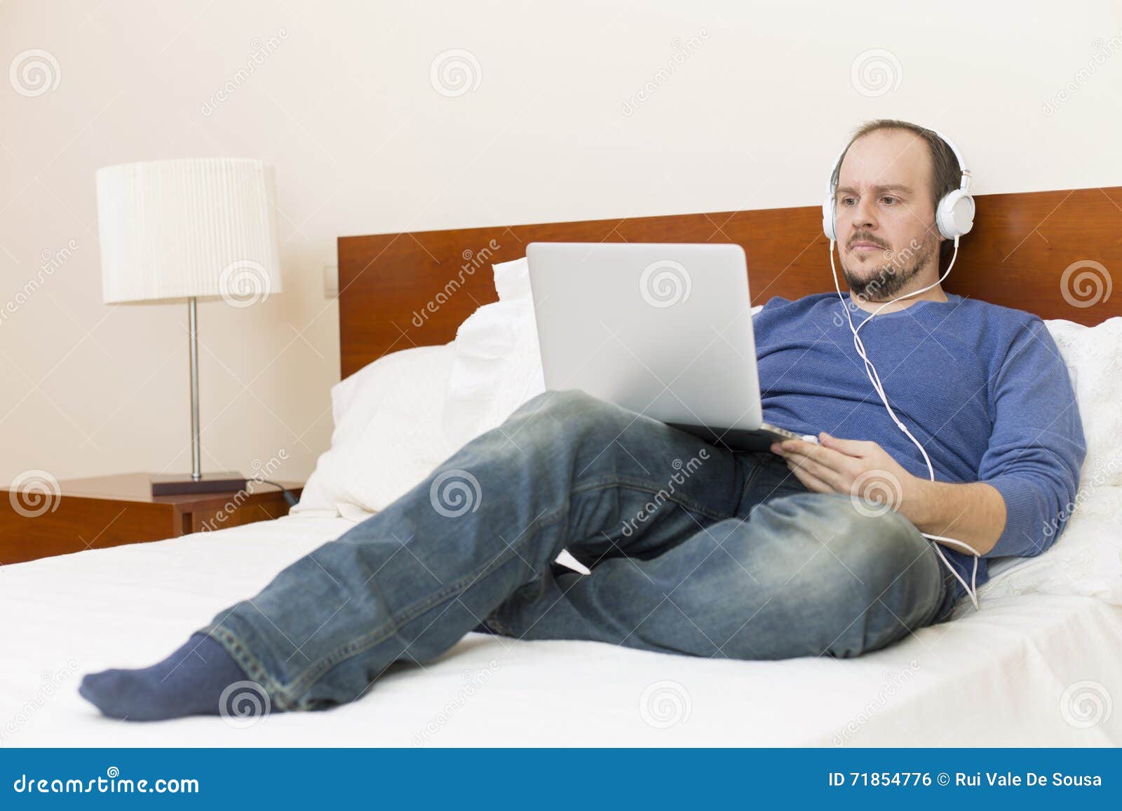 Working in bed stock photo. Image of cheerful, online - 71854776
