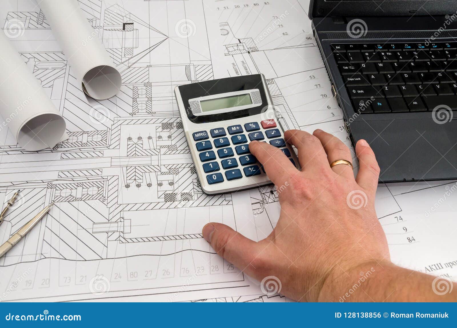 Man Works with the Technical Drawing, and a Laptop Stock Photo - Image ...