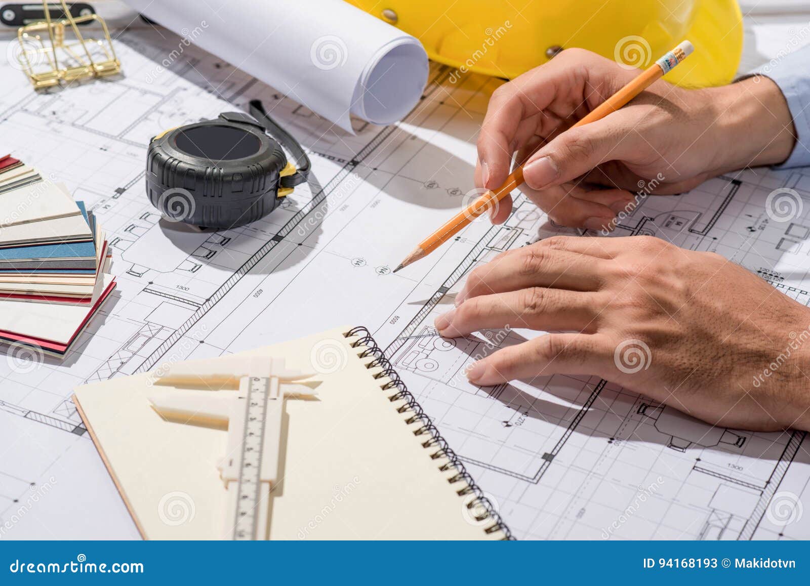 Working on Blueprints. Construction Project with Tools and Notebook ...