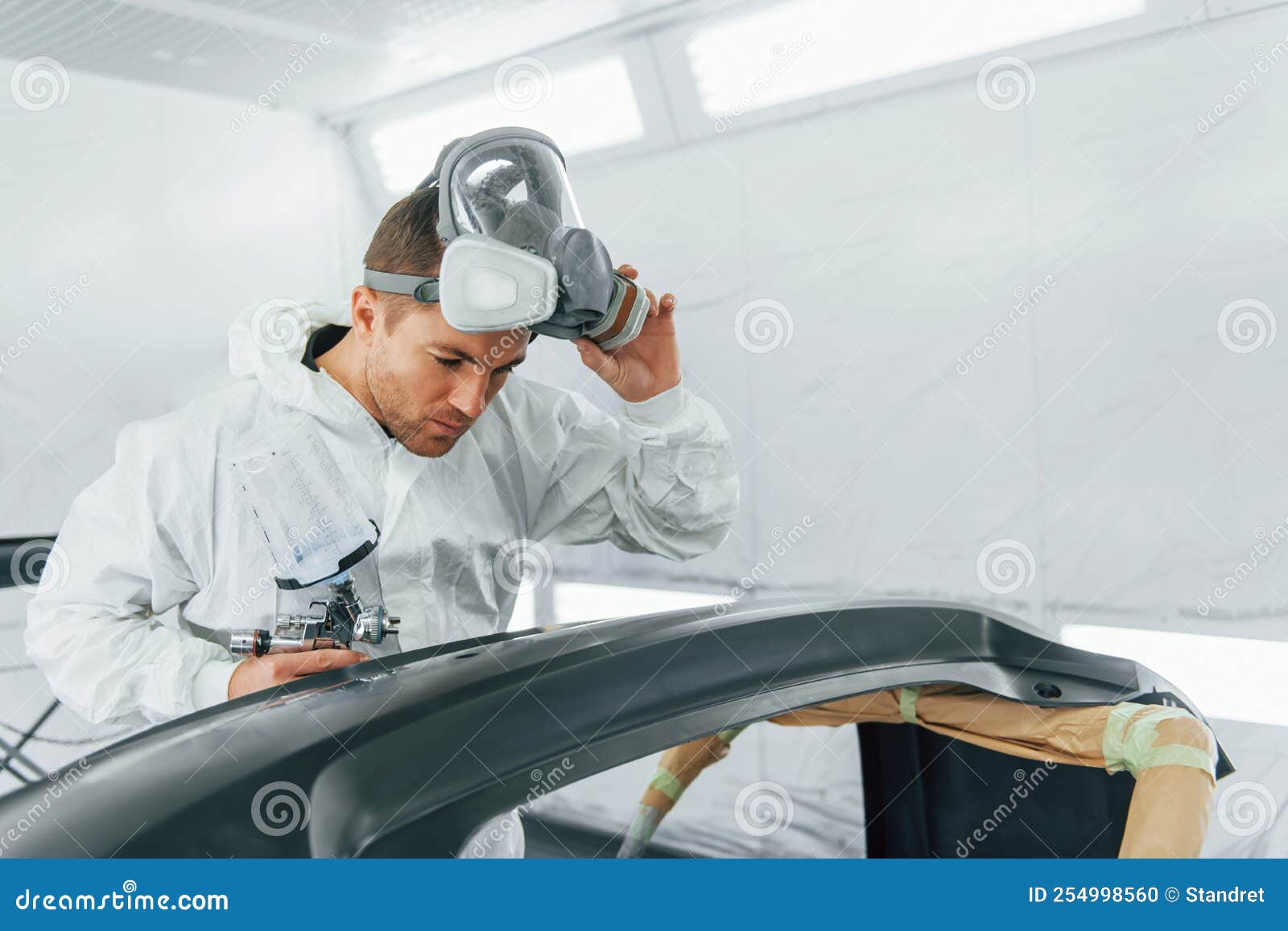 Working with Car Surface. Man in Uniform is Working in the Auto Service ...