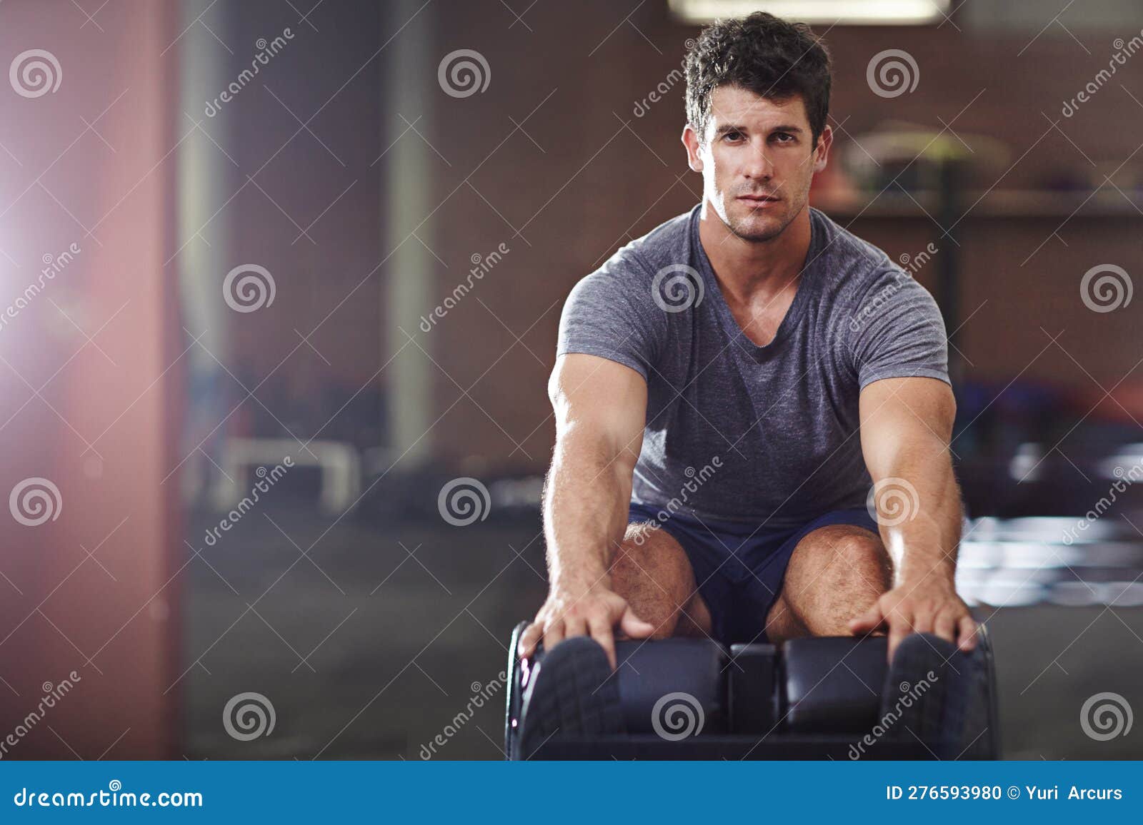 Working from the Core Out. a Young Man Doing Sit Ups in a Gym. Stock ...