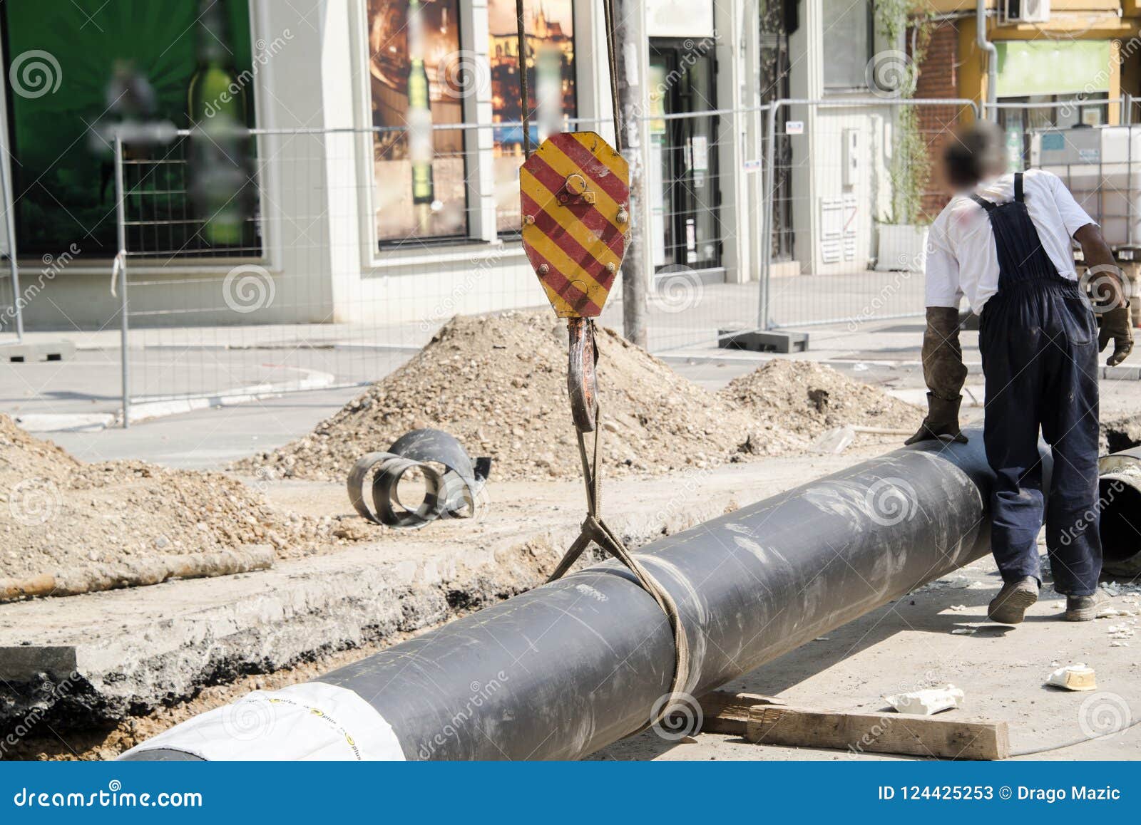 Working with a Crane and Lifting Pipes on the Building Stock Image ...