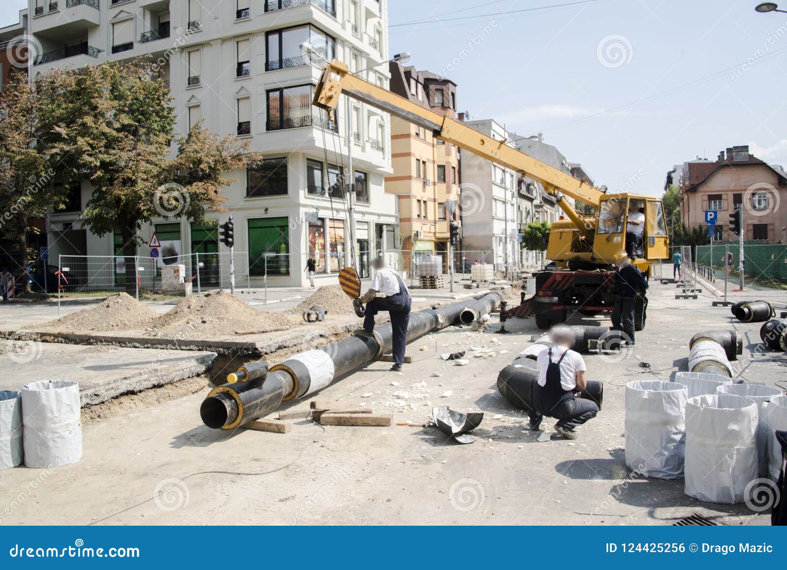 Working with a Crane and Lifting Pipes on the Building Stock Photo ...