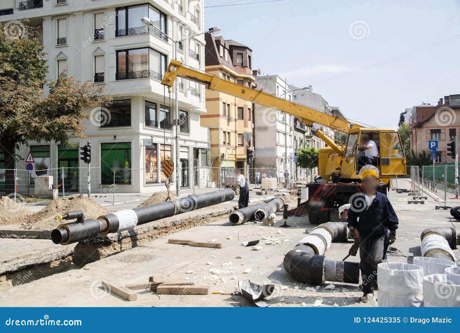 Working with a Crane and Lifting Pipes on the Building Stock Image ...