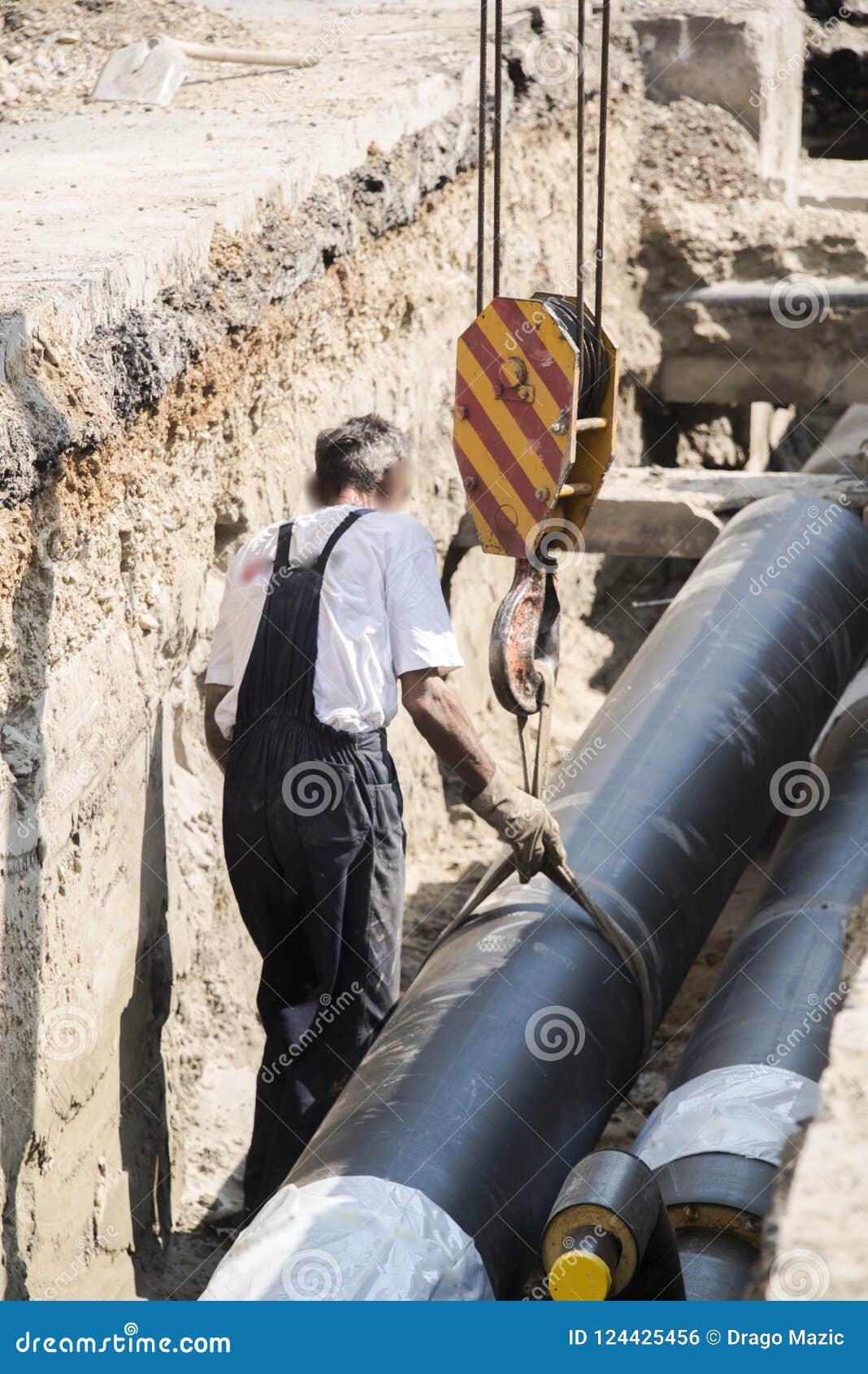 Working with a Crane and Lifting Pipes on the Building Stock Photo ...