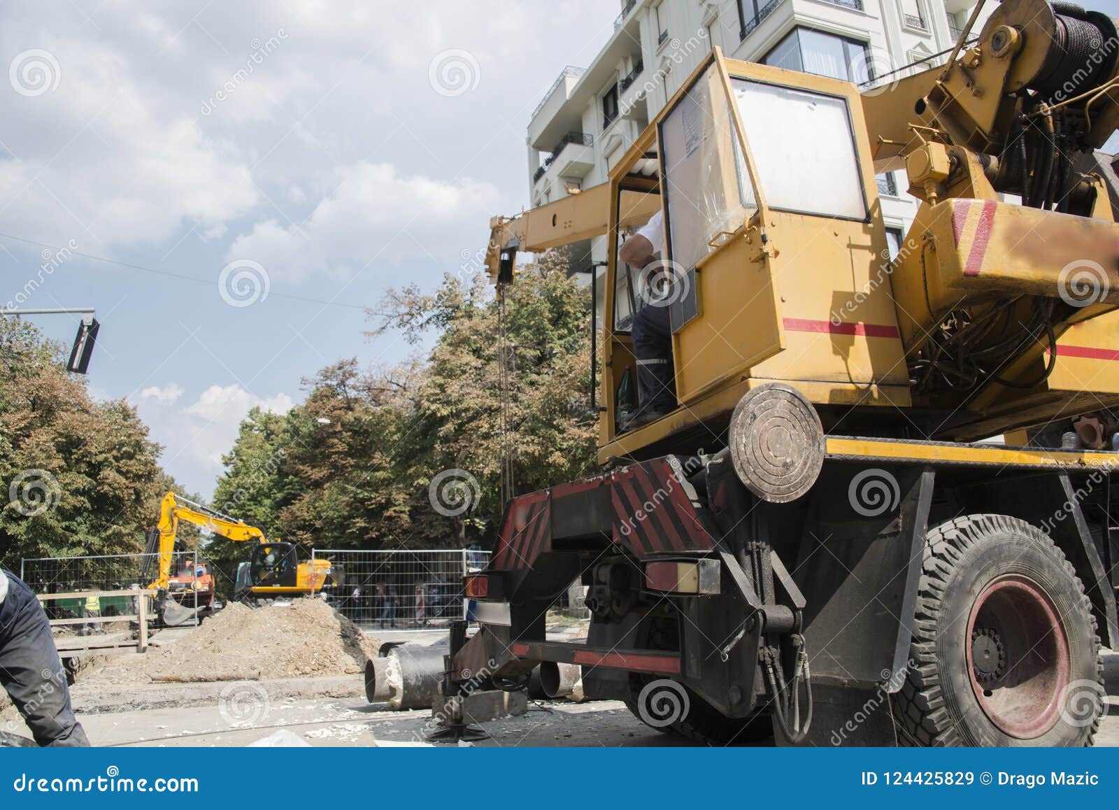 Working with a Crane and Lifting Pipes on the Building Stock Image ...