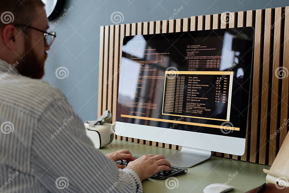Working at Desk with Computer Screen Reflecting Code Stock Image ...