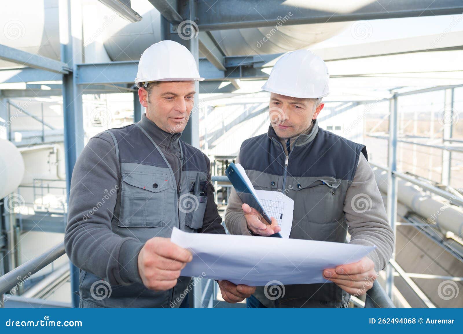 Working Engineers with Project or Drawing Plan Stock Photo - Image of ...