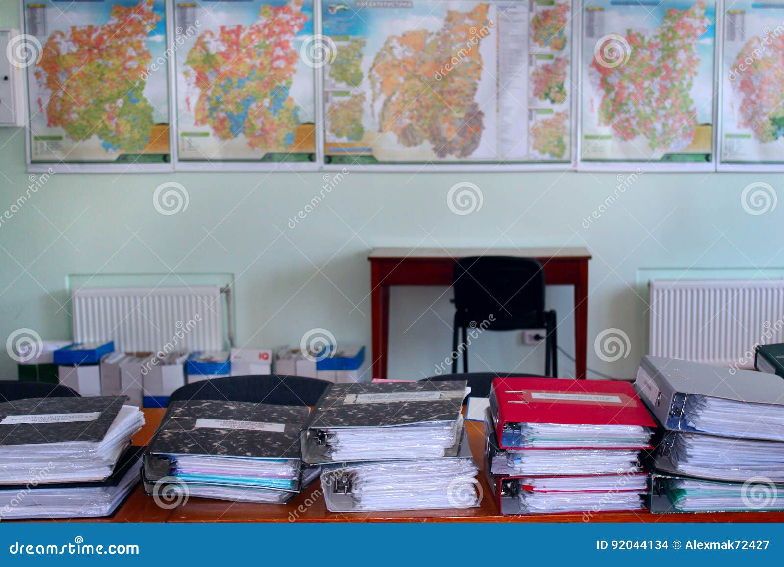 Working Folders in the Office with Maps on the Wall Stock Photo - Image ...