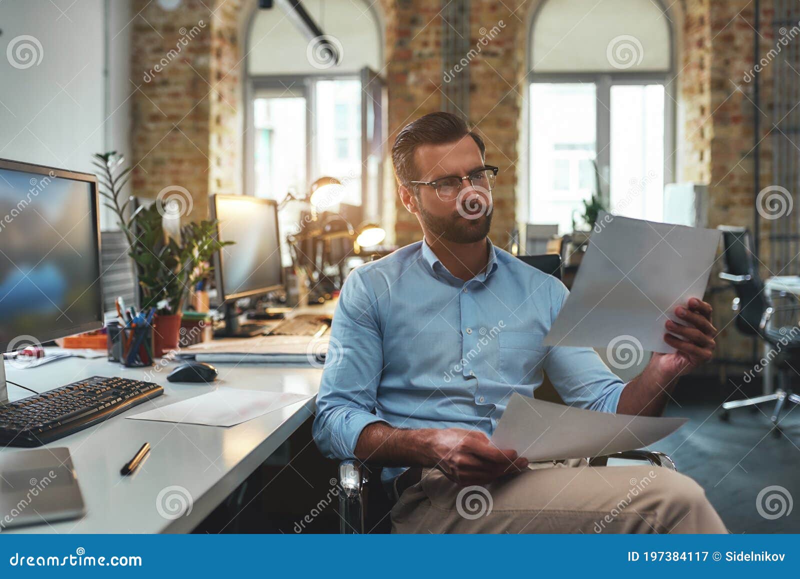 Working Hard Concentrated Bearded Man In Eyeglasses And Formal Wear