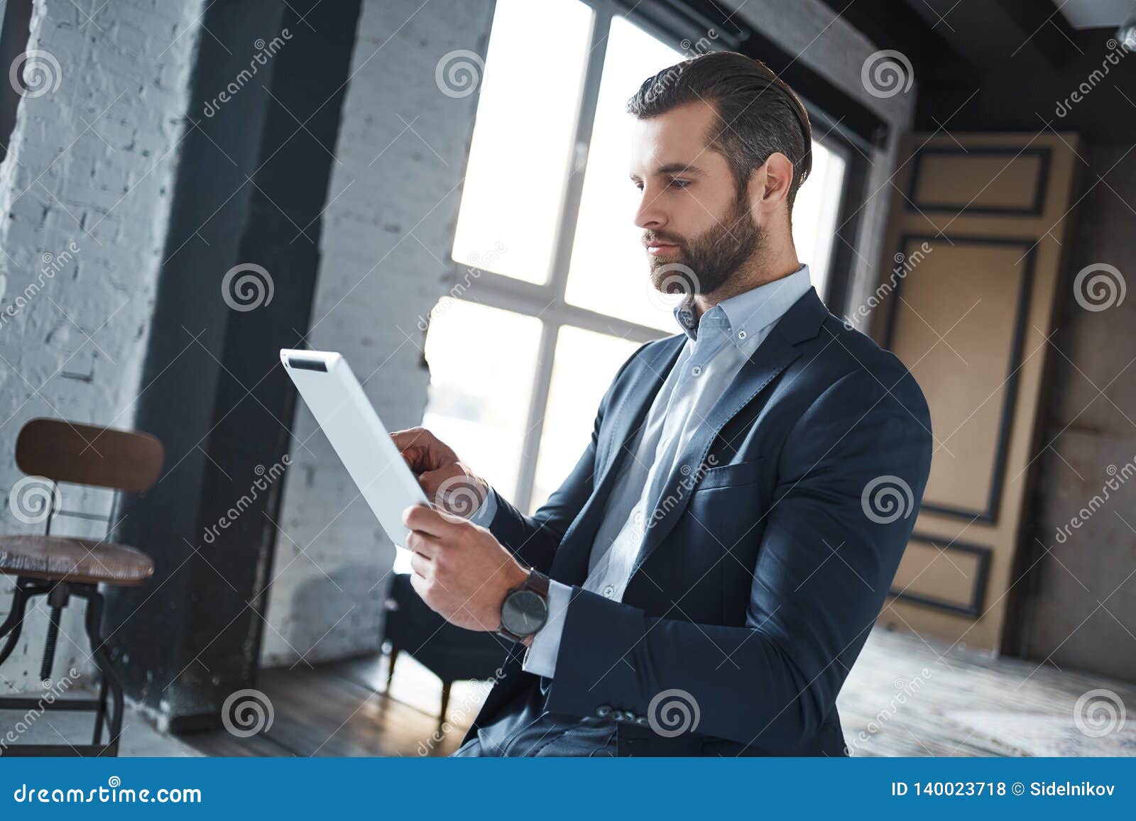 Working Hard Confident and Young Businessman in Stylish Suit is Using ...