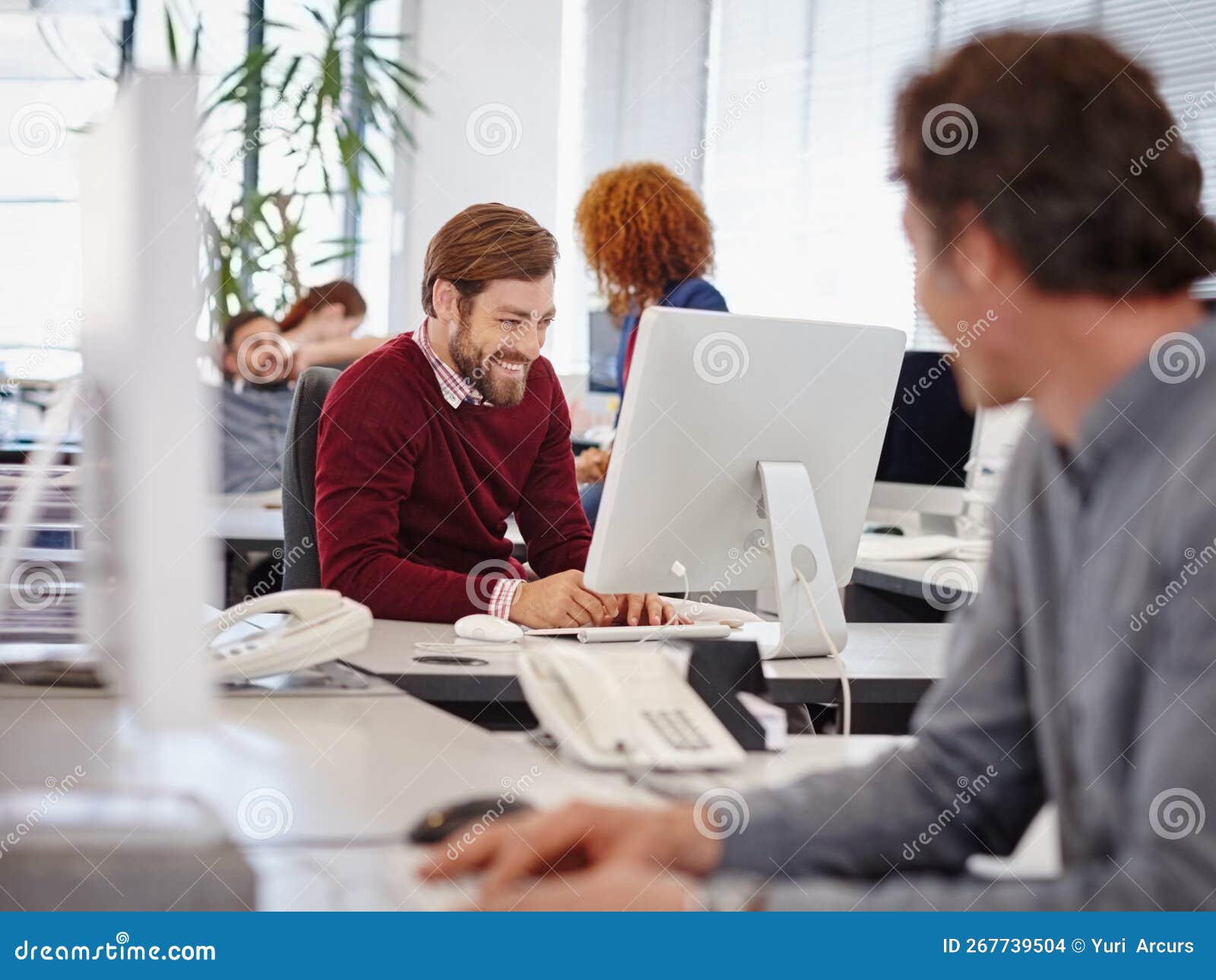 Working Hard or Hardly Working. Business Colleagues Working on ...