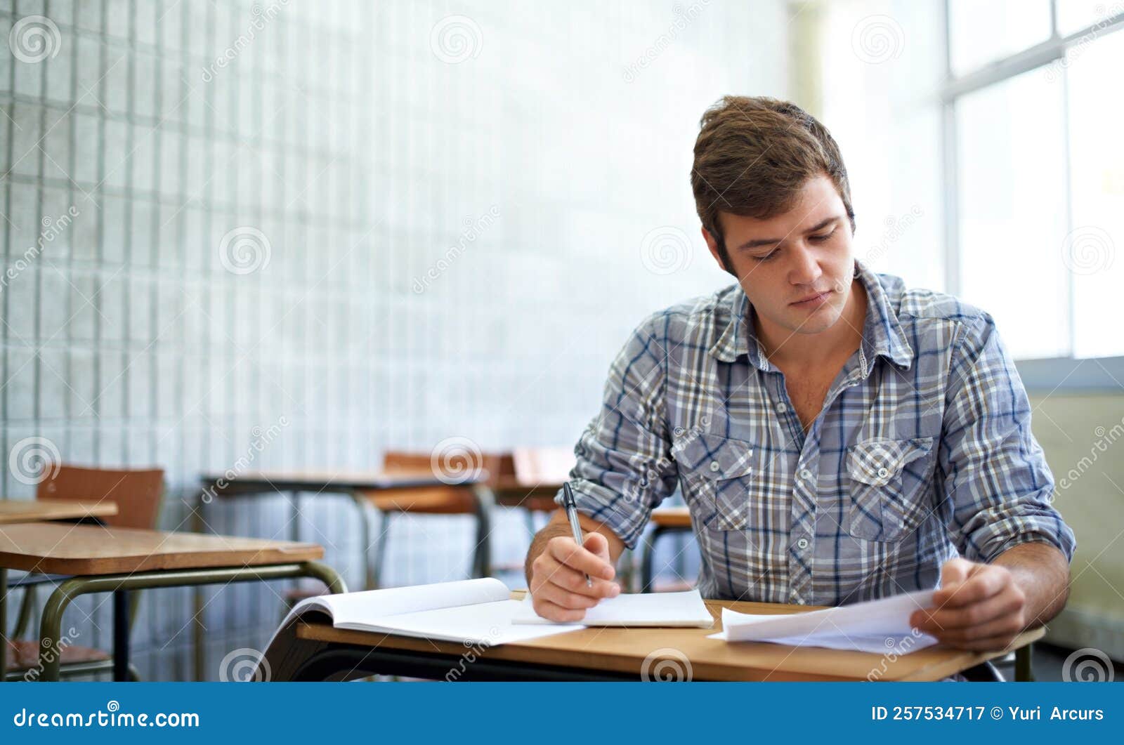 Working Hard To Achieve Excellence. a Young College Student Studying in ...