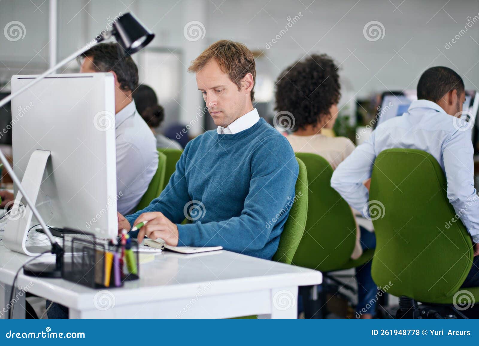 Working Hard To Meet His Deadline. a Group of Creative Businesspeople ...