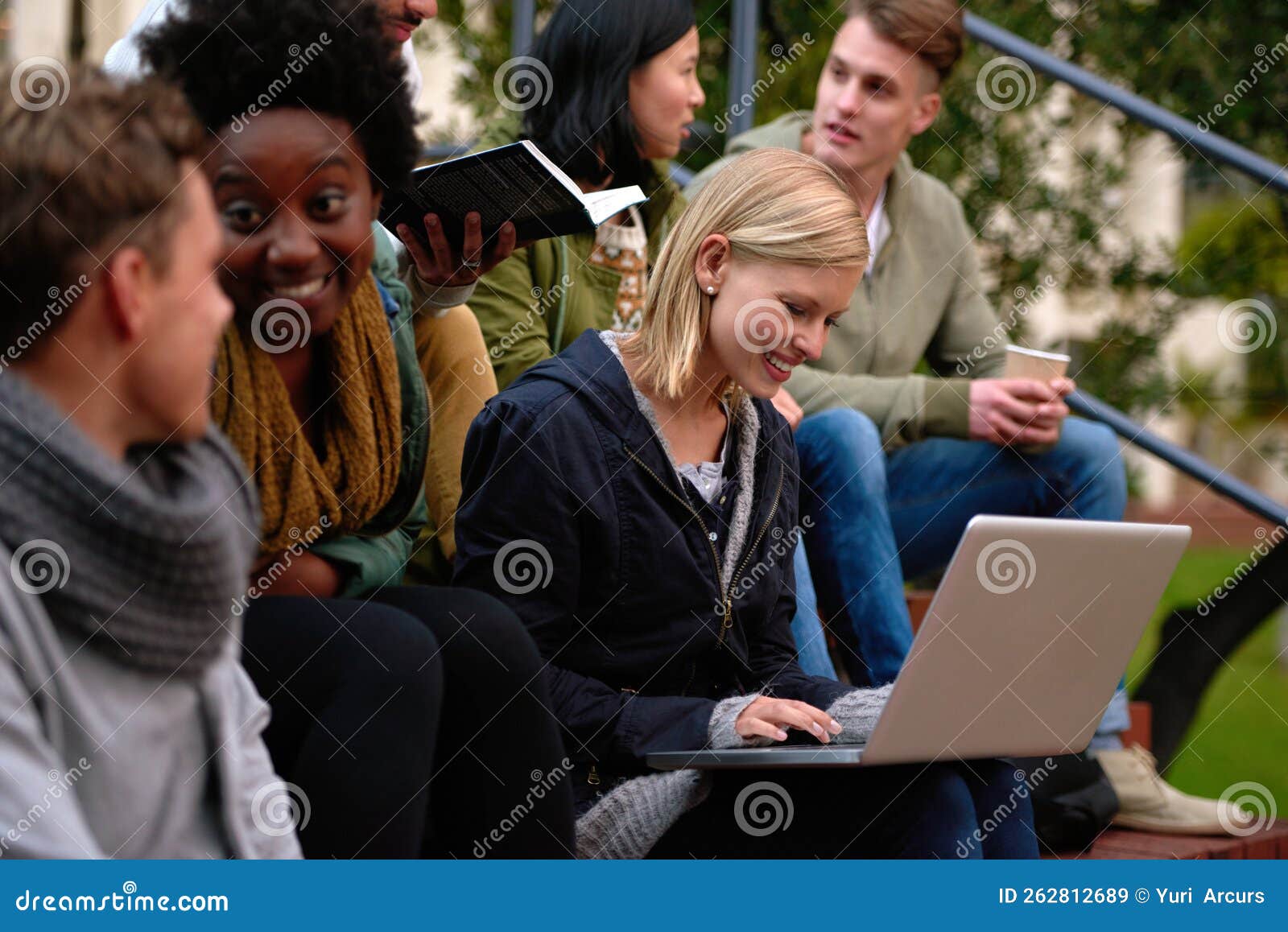 Working on Her Project. a Group Students Looking at a Laptop on Campus ...