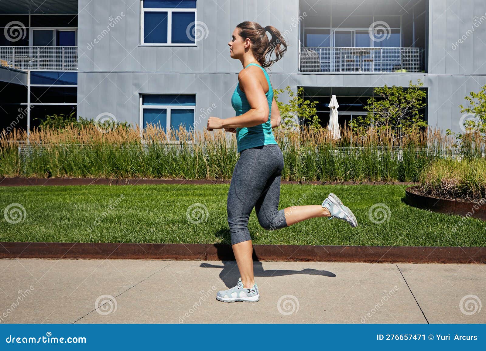 Working on Herself Lap by Lap. an Attractive Young Female Runner ...