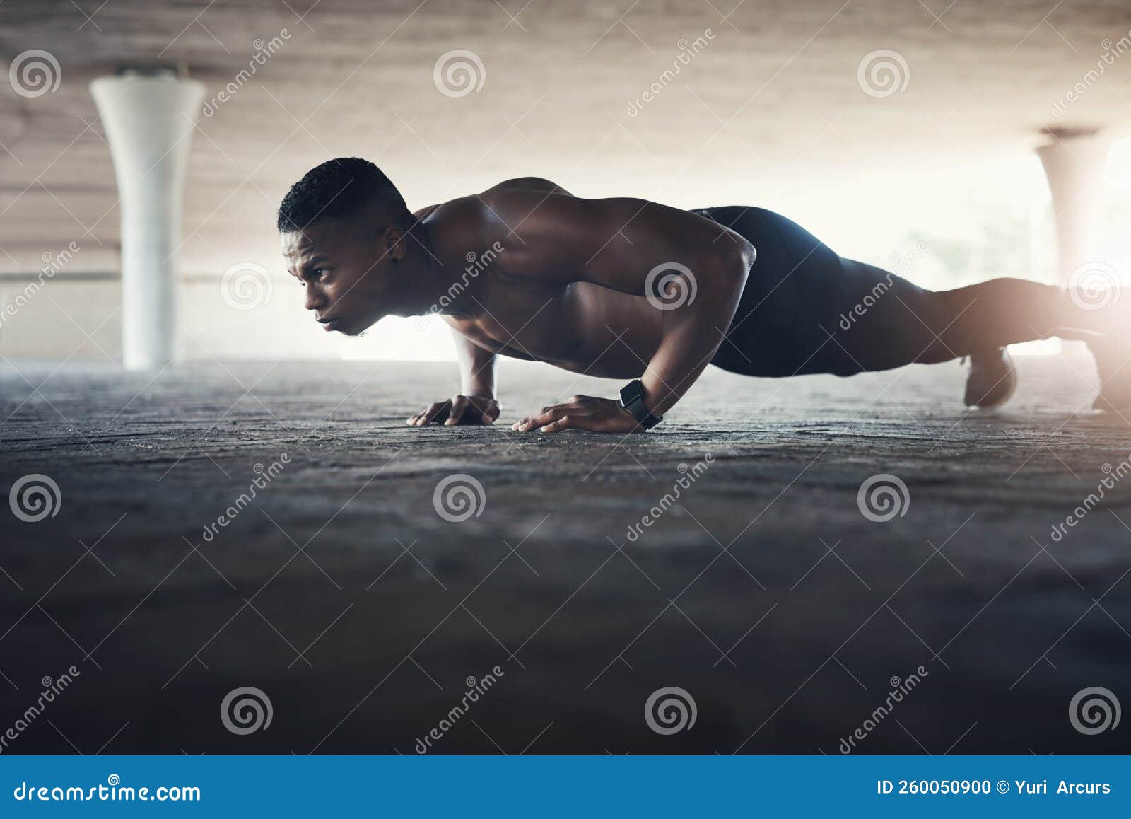 Working on His Upper Body. a Handsome Young Man Doing Pushups while ...