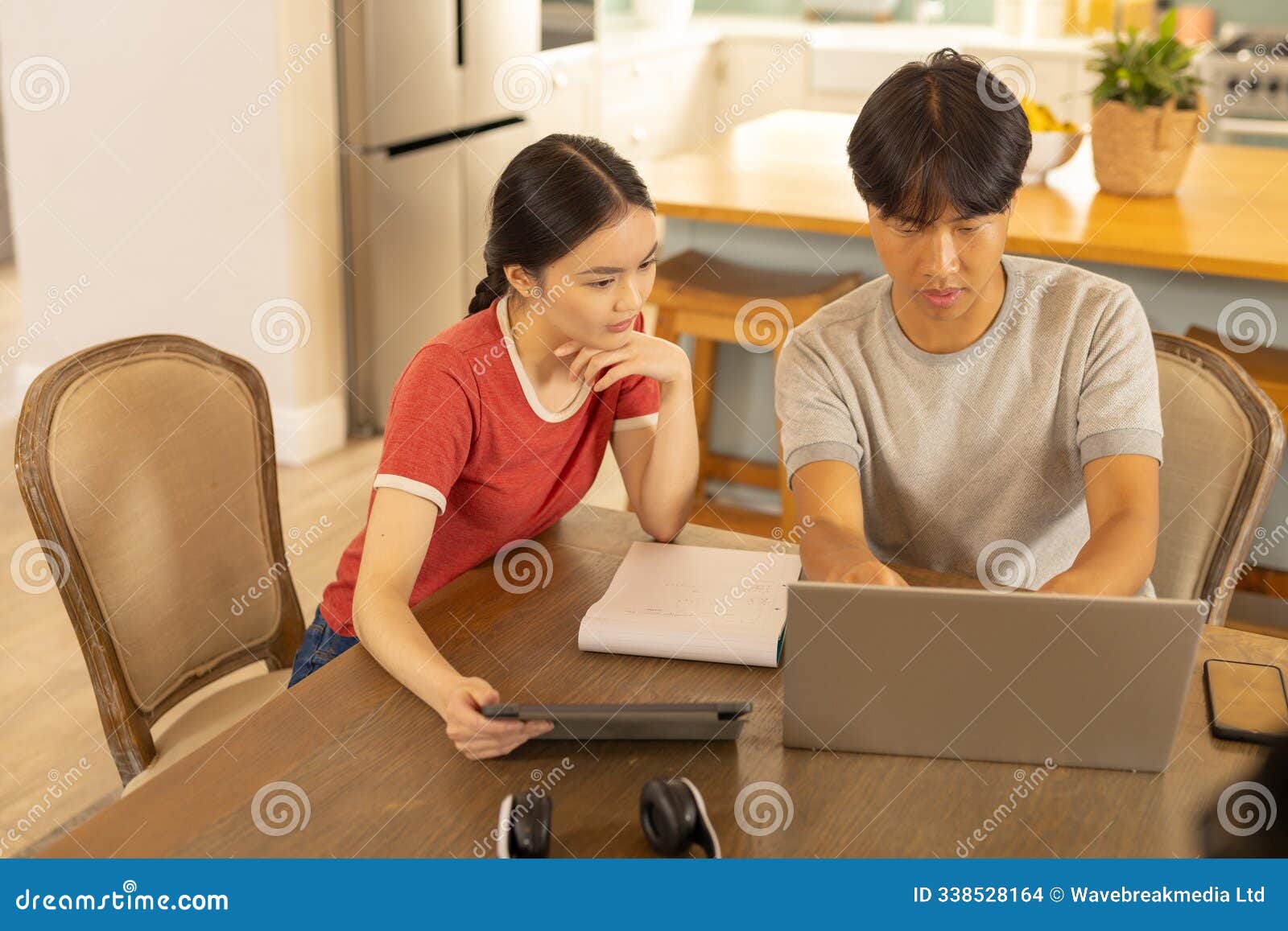Working from Home, Asian Brother and Sister Using Laptop and Tablet at ...