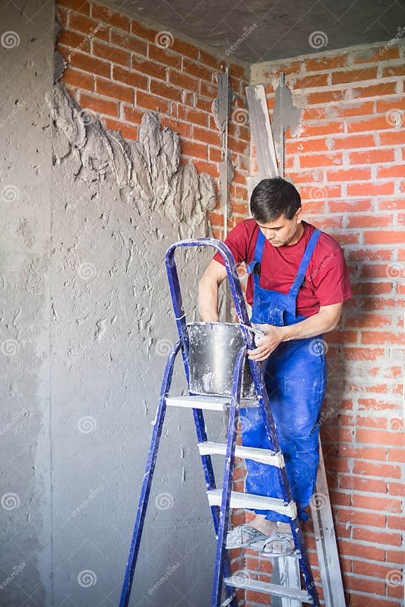 Working on a Ladder Preparing the Plaster in a Stock Photo - Image of ...